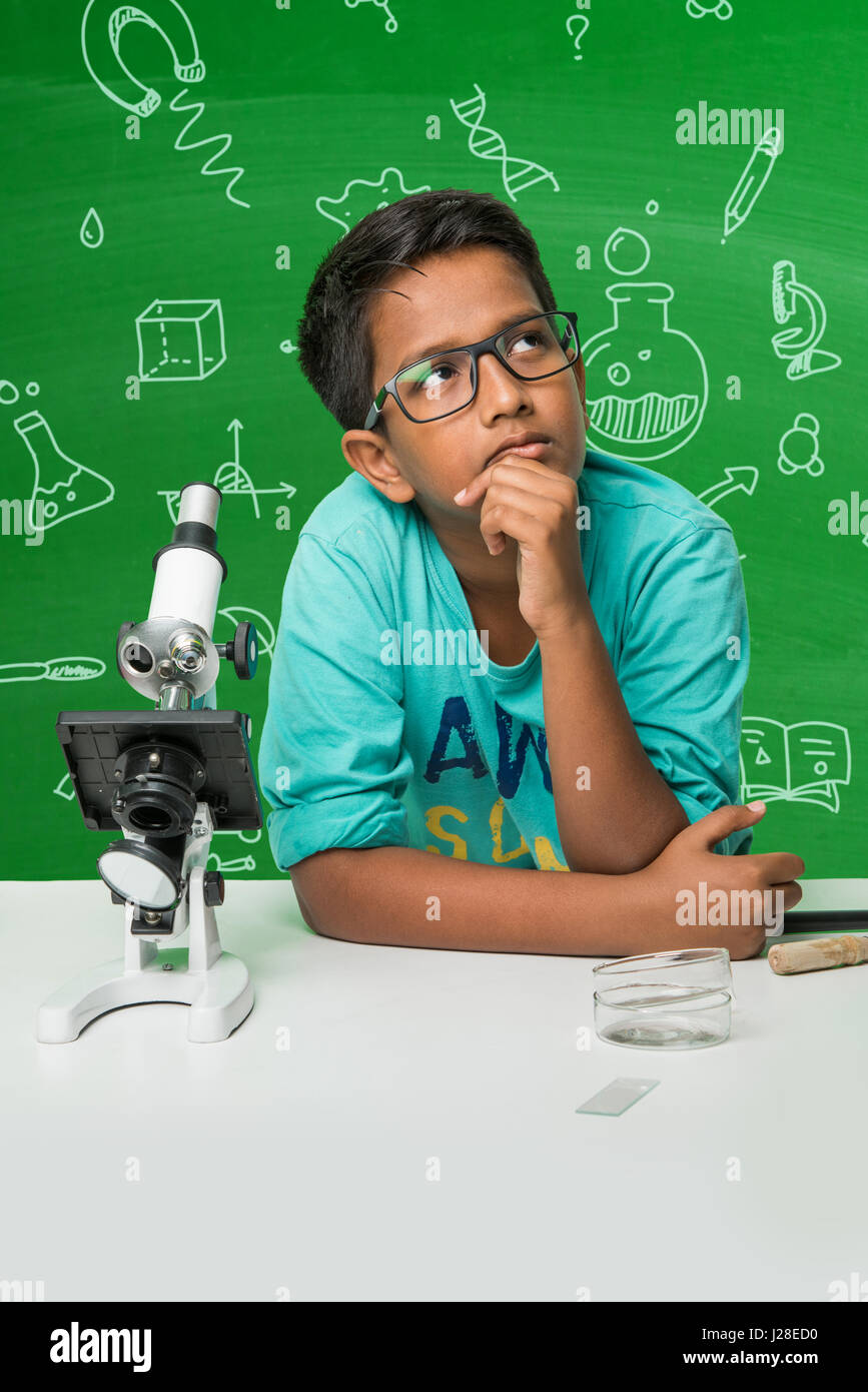 cute indian kids doing science experiment in chemistry lab or biology ...