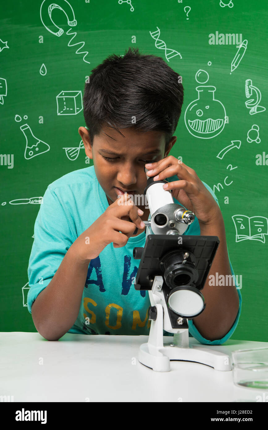 cute indian kids doing science experiment in chemistry lab or biology ...