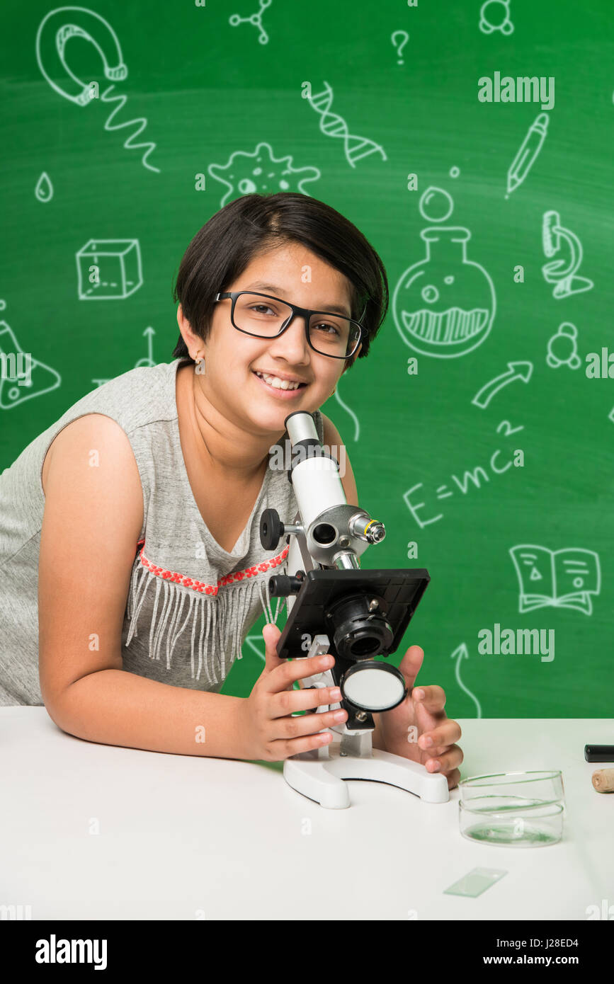 cute indian kids doing science experiment in chemistry lab or biology ...