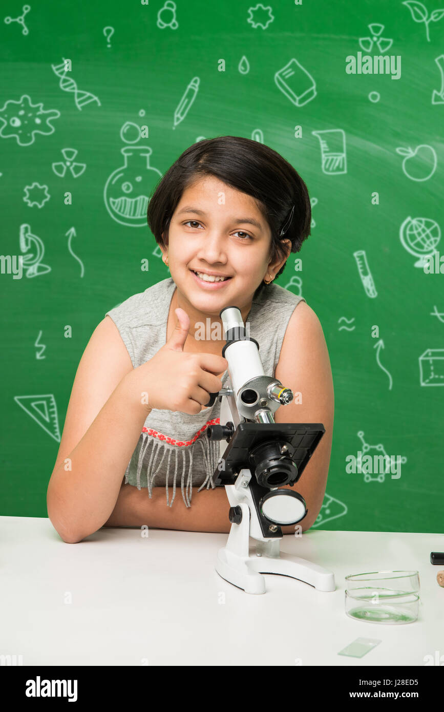 cute indian kids doing science experiment in chemistry lab or biology ...