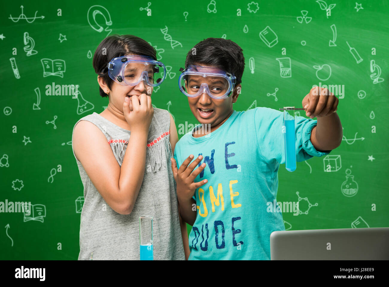 cute indian kids doing science experiment in chemistry lab or biology ...