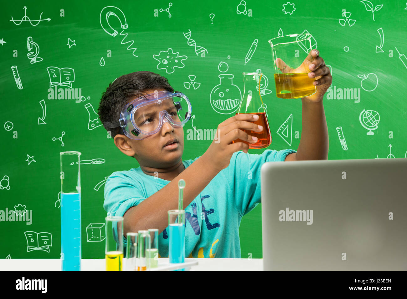 cute indian kids doing science experiment in chemistry lab or biology ...