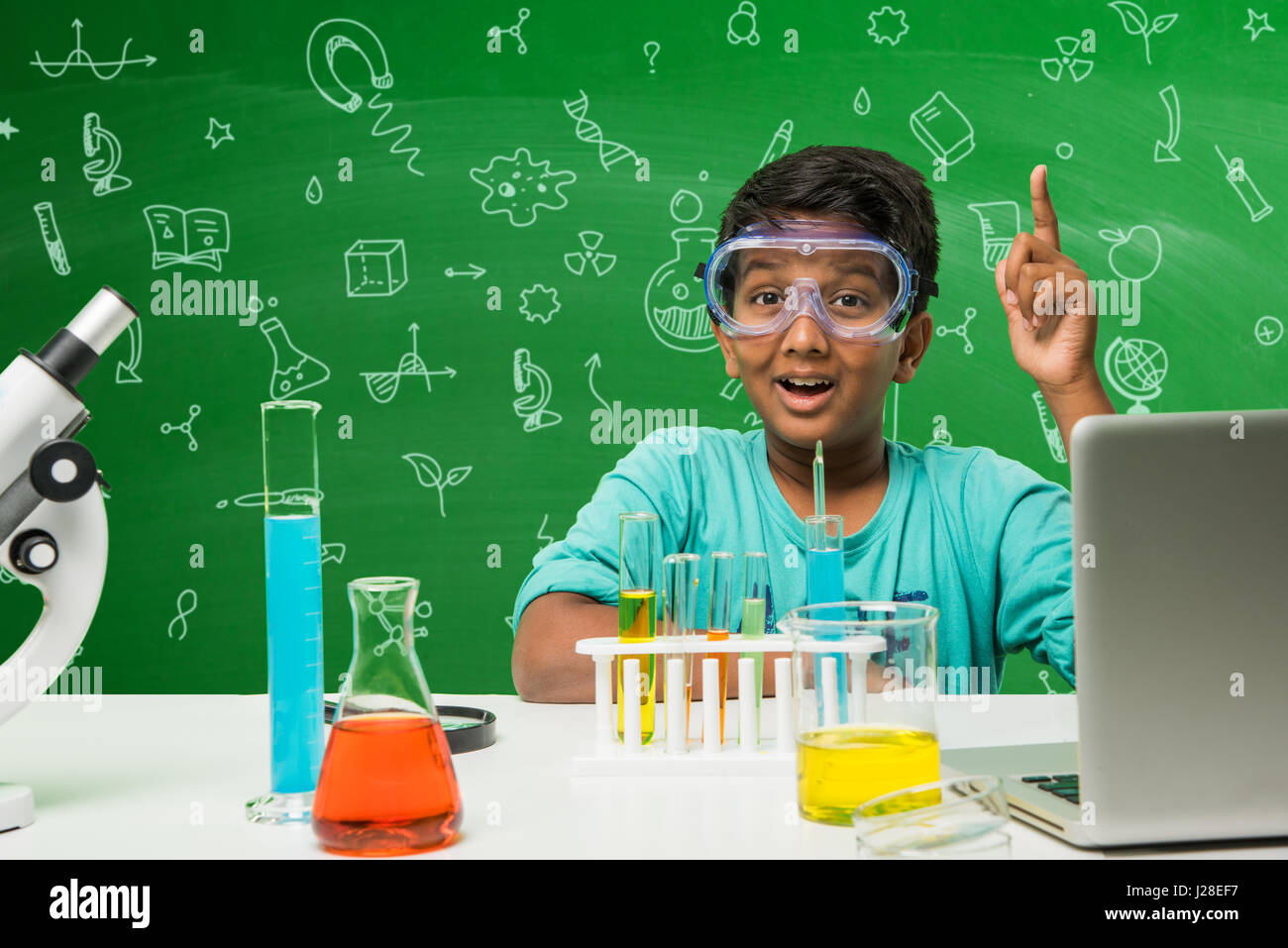 cute indian kids doing science experiment in chemistry lab or biology ...