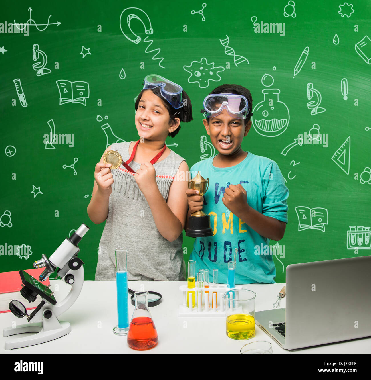 cute indian kids doing science experiment in chemistry lab or biology ...