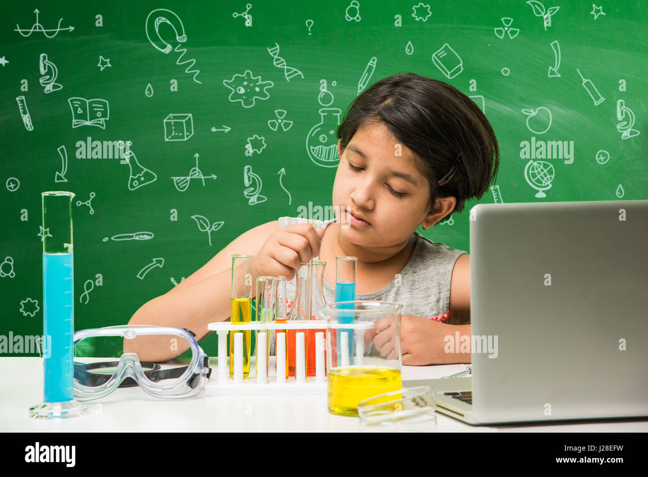 cute indian kids doing science experiment in chemistry lab or biology ...