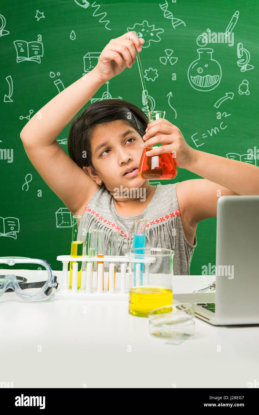 cute indian kids doing science experiment in chemistry lab or biology ...