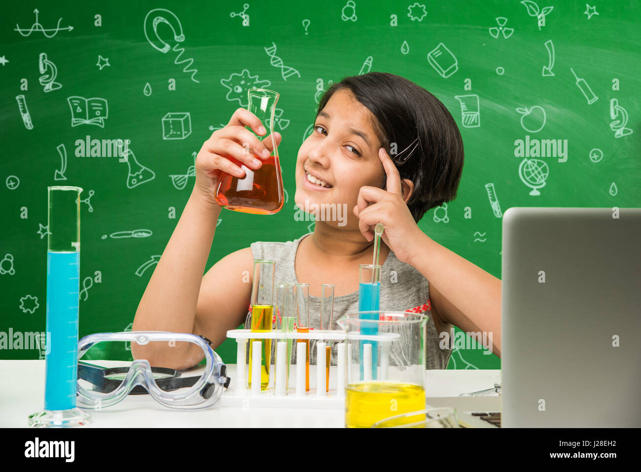 cute indian kids doing science experiment in chemistry lab or biology ...