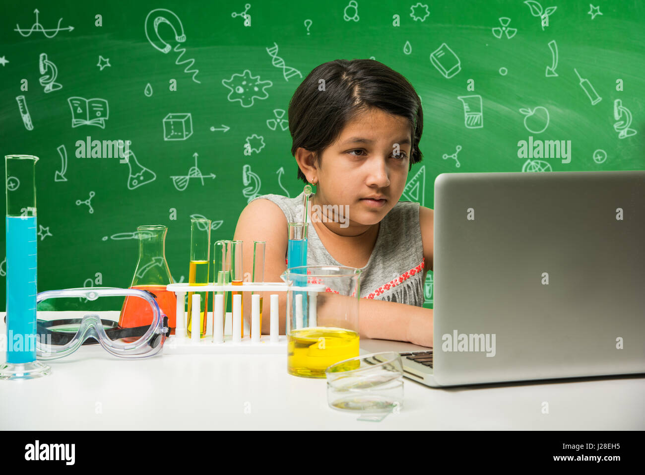 cute indian kids doing science experiment in chemistry lab or biology ...