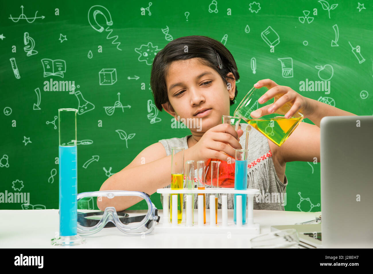 cute indian kids doing science experiment in chemistry lab or biology ...