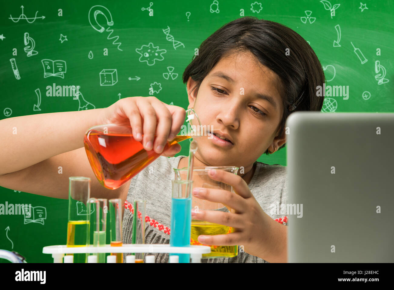 cute indian kids doing science experiment in chemistry lab or biology ...