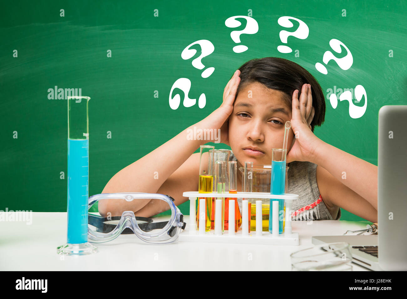 cute indian kids doing science experiment in chemistry lab or biology ...