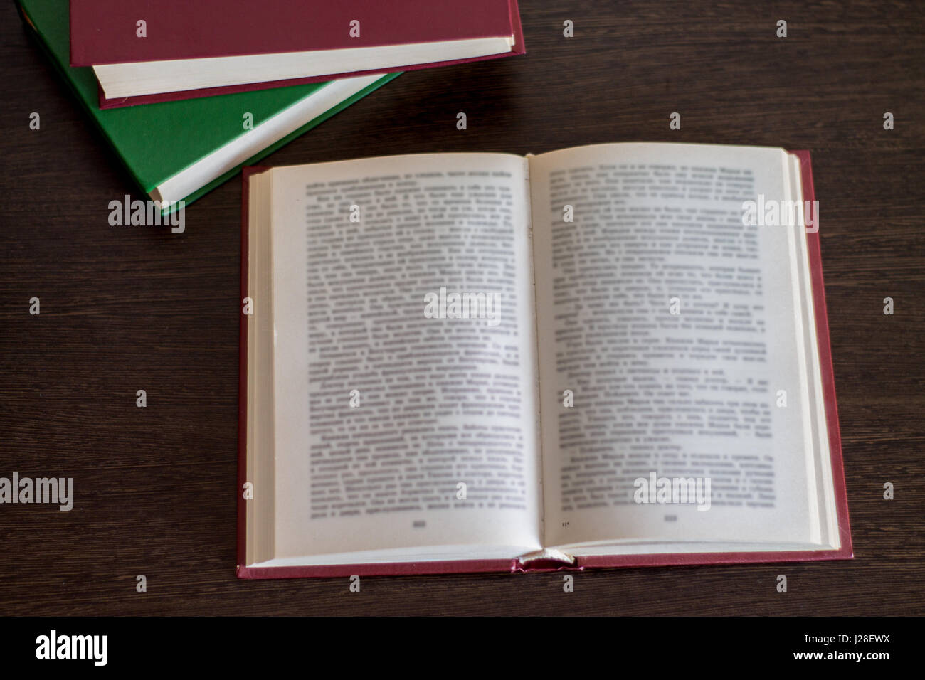 Opened book on an empty wooden table Stock Photo - Alamy