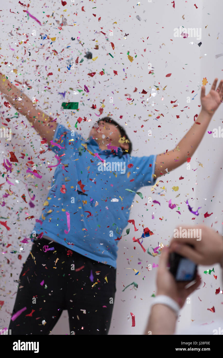 Happy kid celebrating party with blowing confetti Stock Photo - Alamy