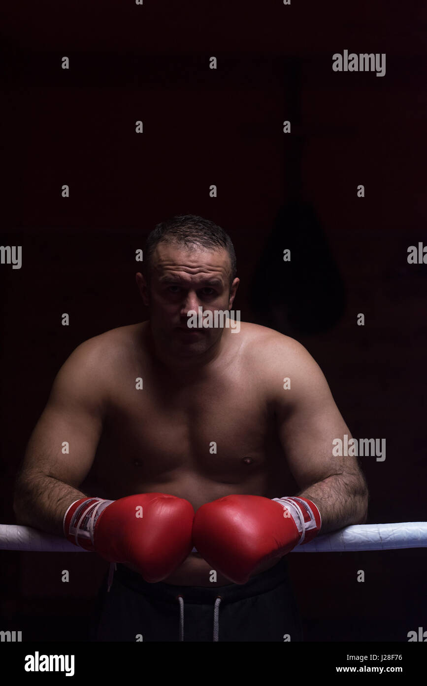 portrait of muscular professional kickboxer who standing in the ring ...