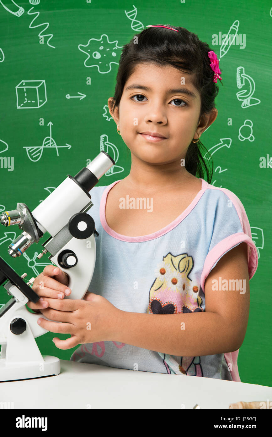 cute indian kids doing science experiment in chemistry lab or biology ...