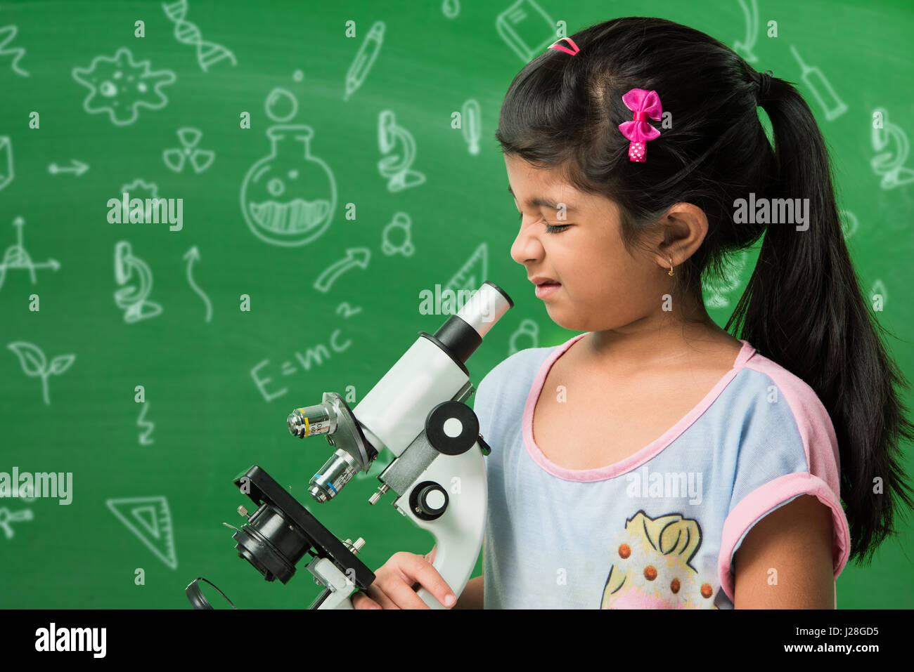 cute indian kids doing science experiment in chemistry lab or biology ...