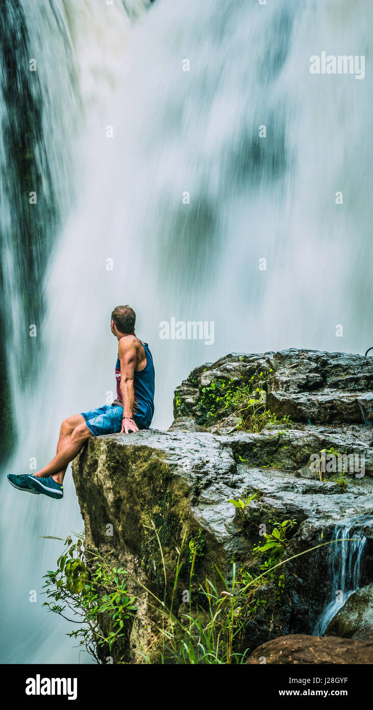 Man sitting in Front of Tegenungan Waterfall near Ubud in Bali ...