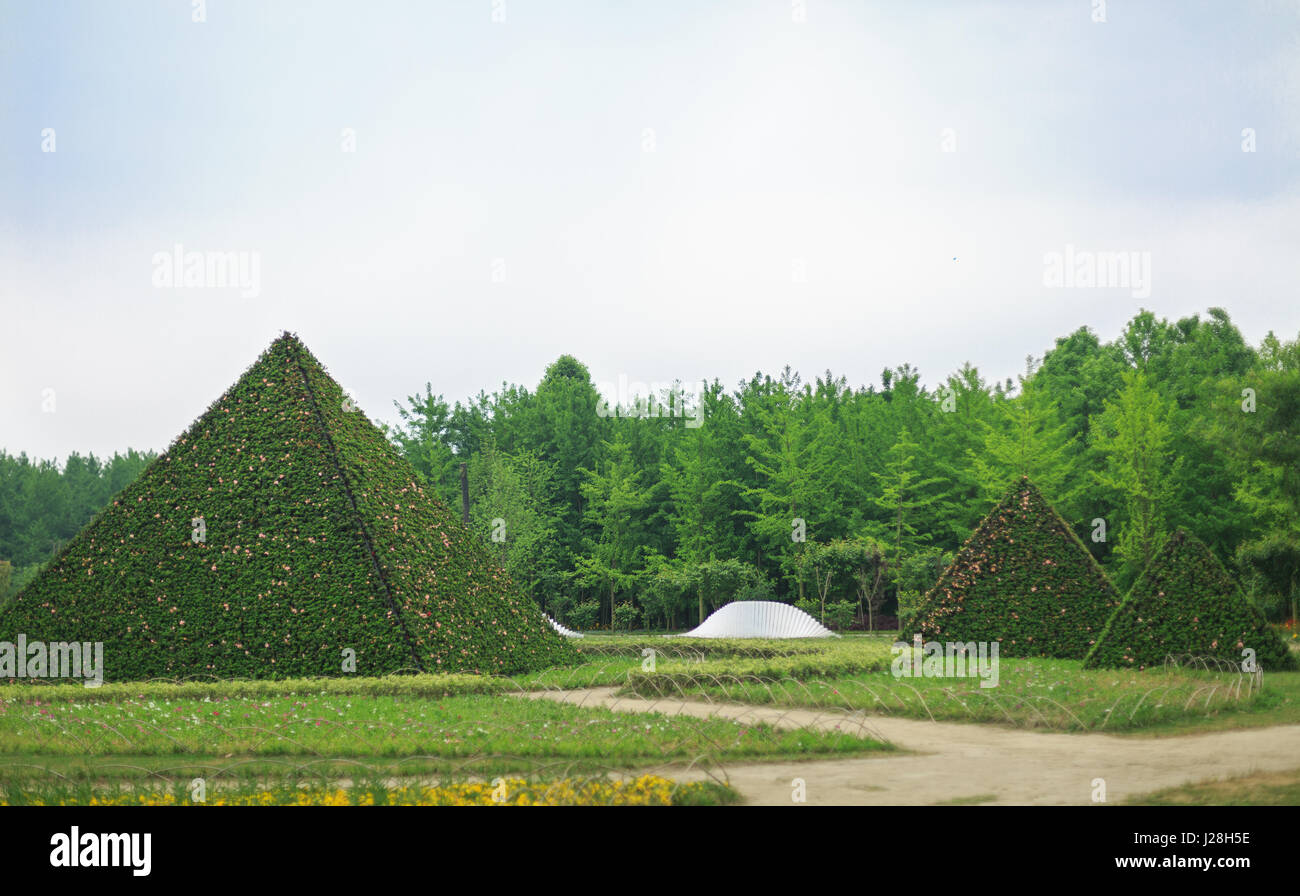 Pyramid shaped flower beds in the garden Stock Photo - Alamy