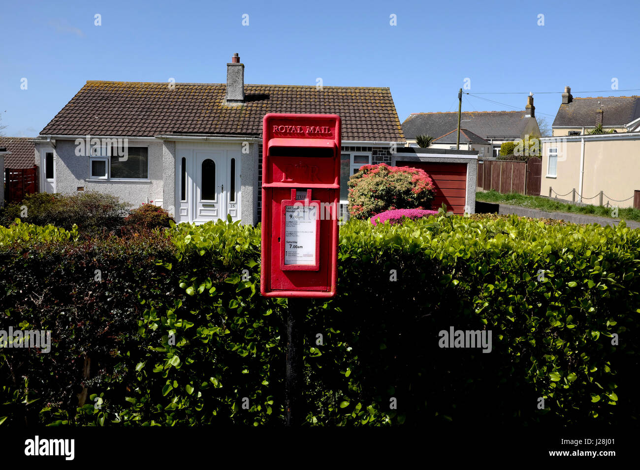 Red post box and green hedge hi-res stock photography and images - Alamy