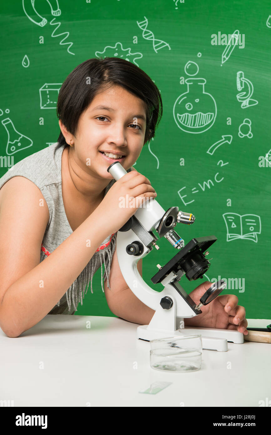 cute indian kids doing science experiment in chemistry lab or biology ...