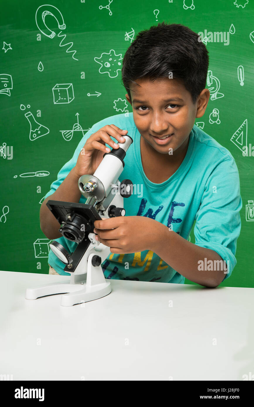 cute indian kids doing science experiment in chemistry lab or biology ...