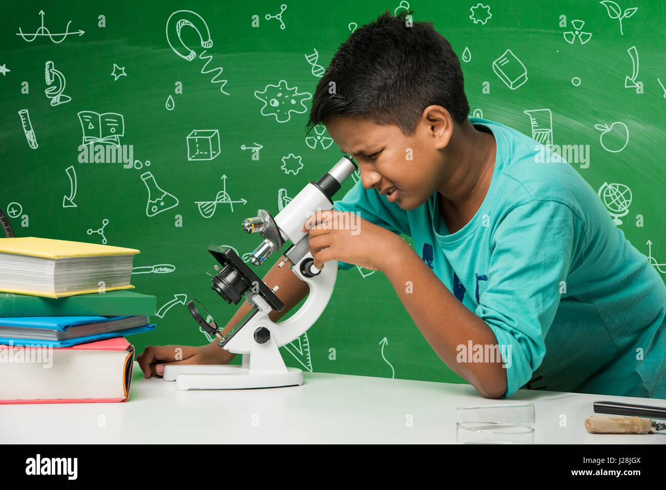 cute indian kids doing science experiment in chemistry lab or biology ...