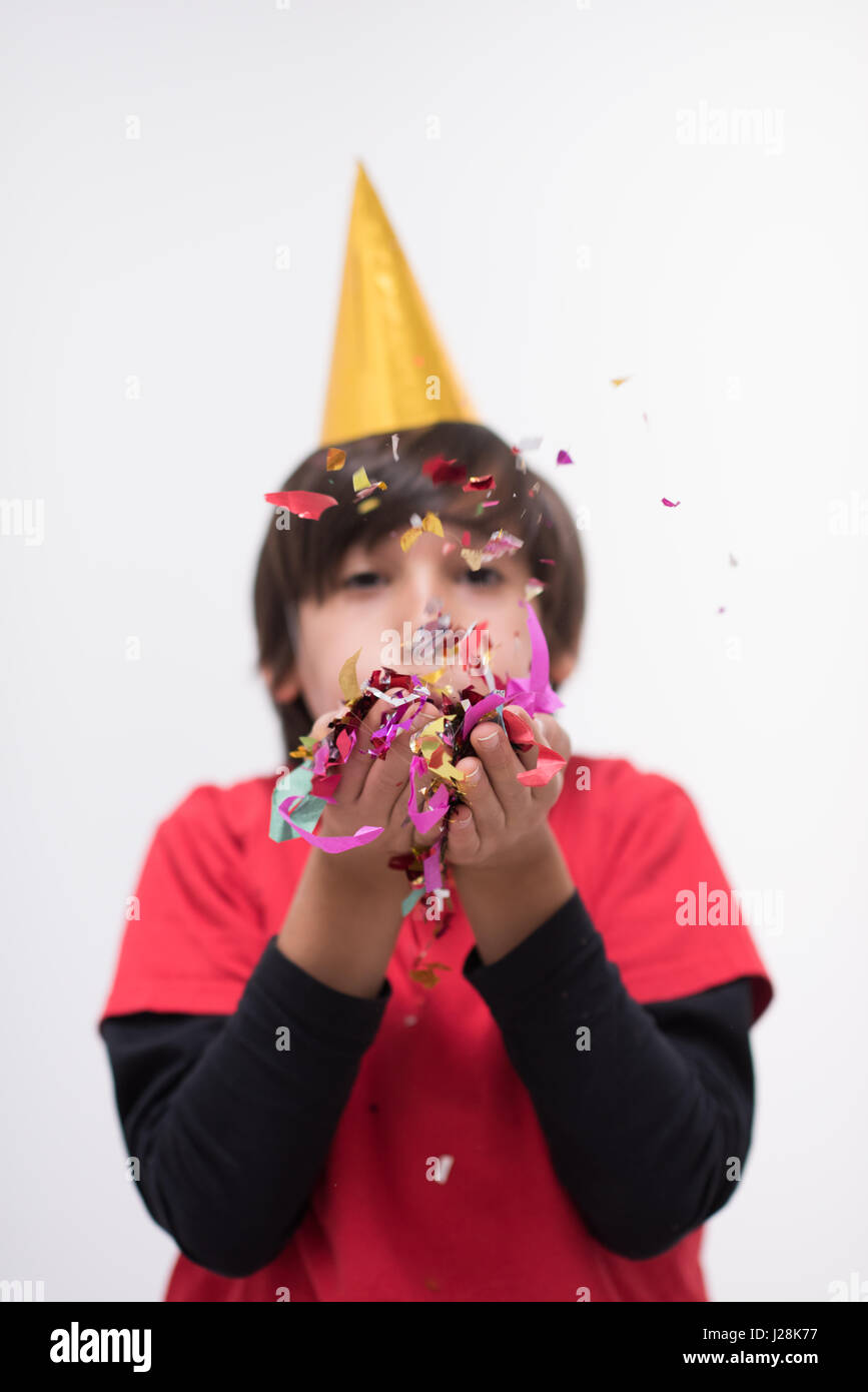 Happy kid celebrating party with blowing confetti Stock Photo - Alamy