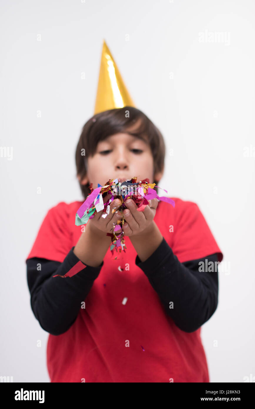 Happy kid celebrating party with blowing confetti Stock Photo - Alamy