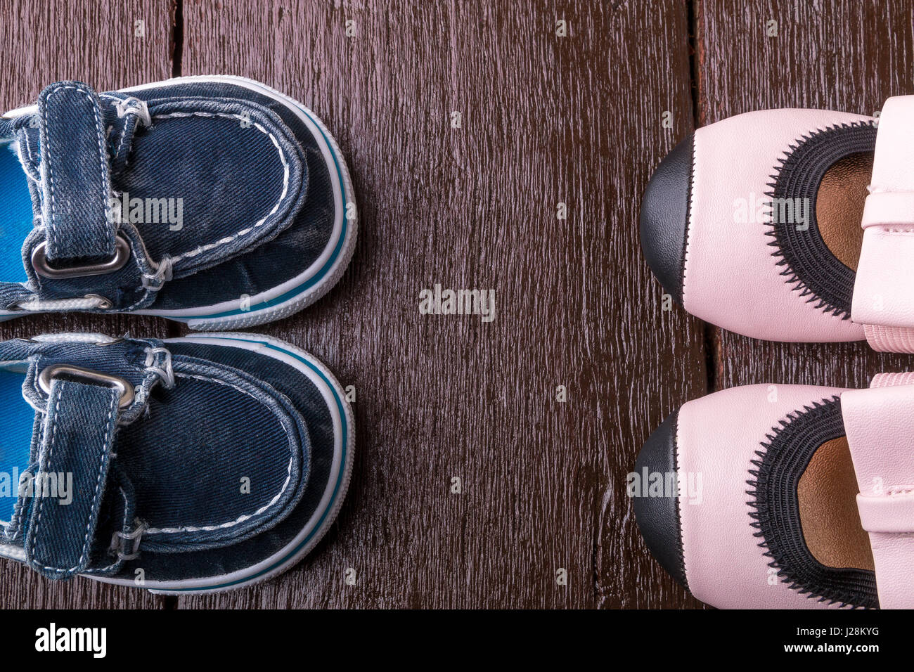 Baby boy and girl shoes on wooden background. Child footwear. Top view ...