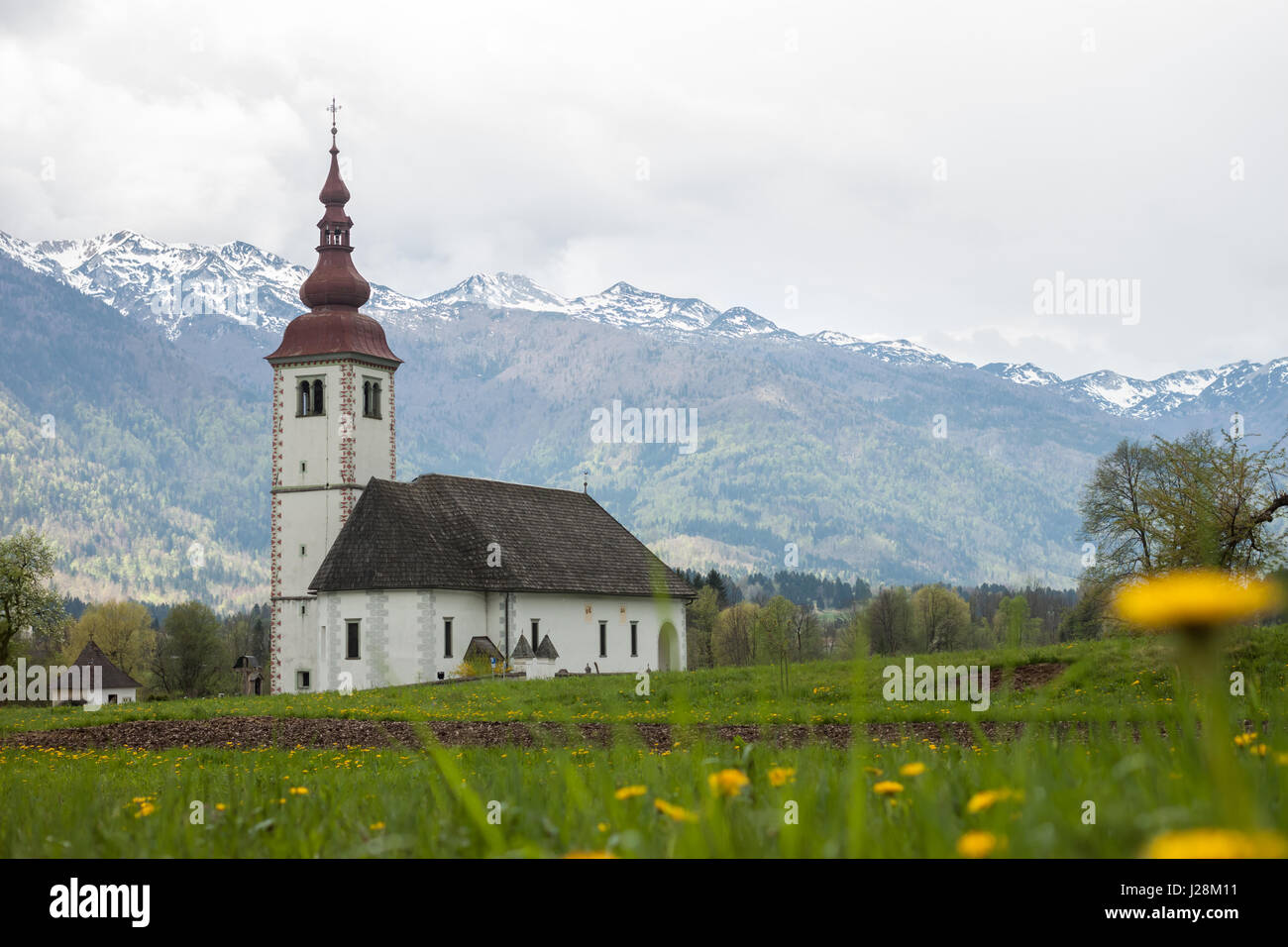 catholic church in field among Alps Stock Photo - Alamy