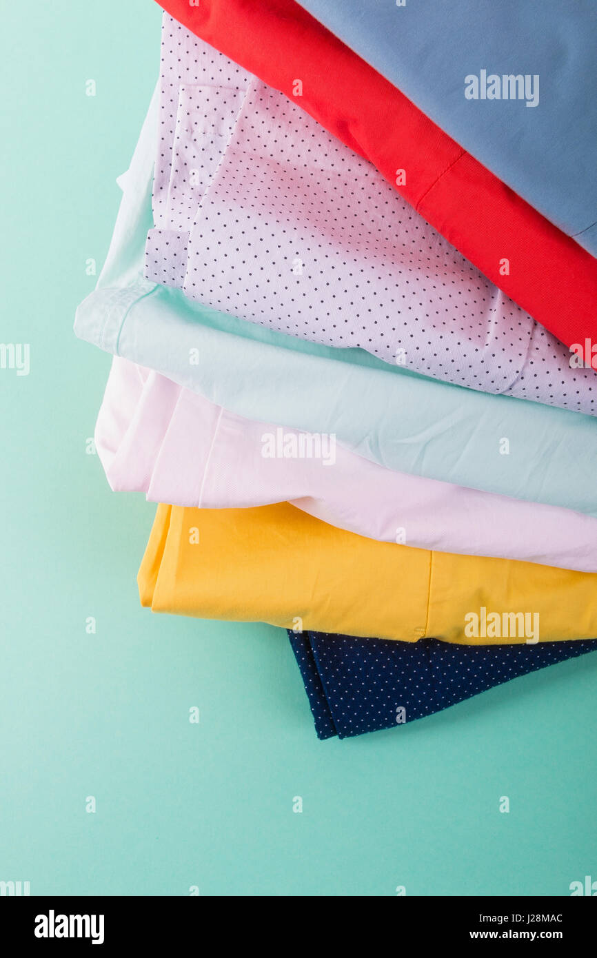 Folded colorful pants and jeans. Stack of bright female trousers. Close ...