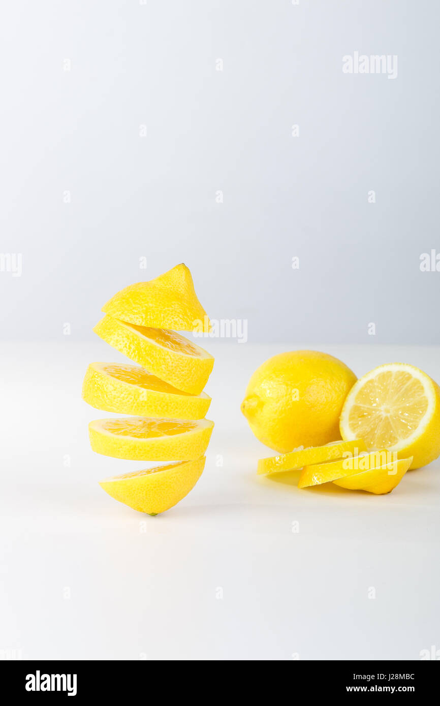 Flying lemon. Sliced lemon on white background. Levity fruit floating ...