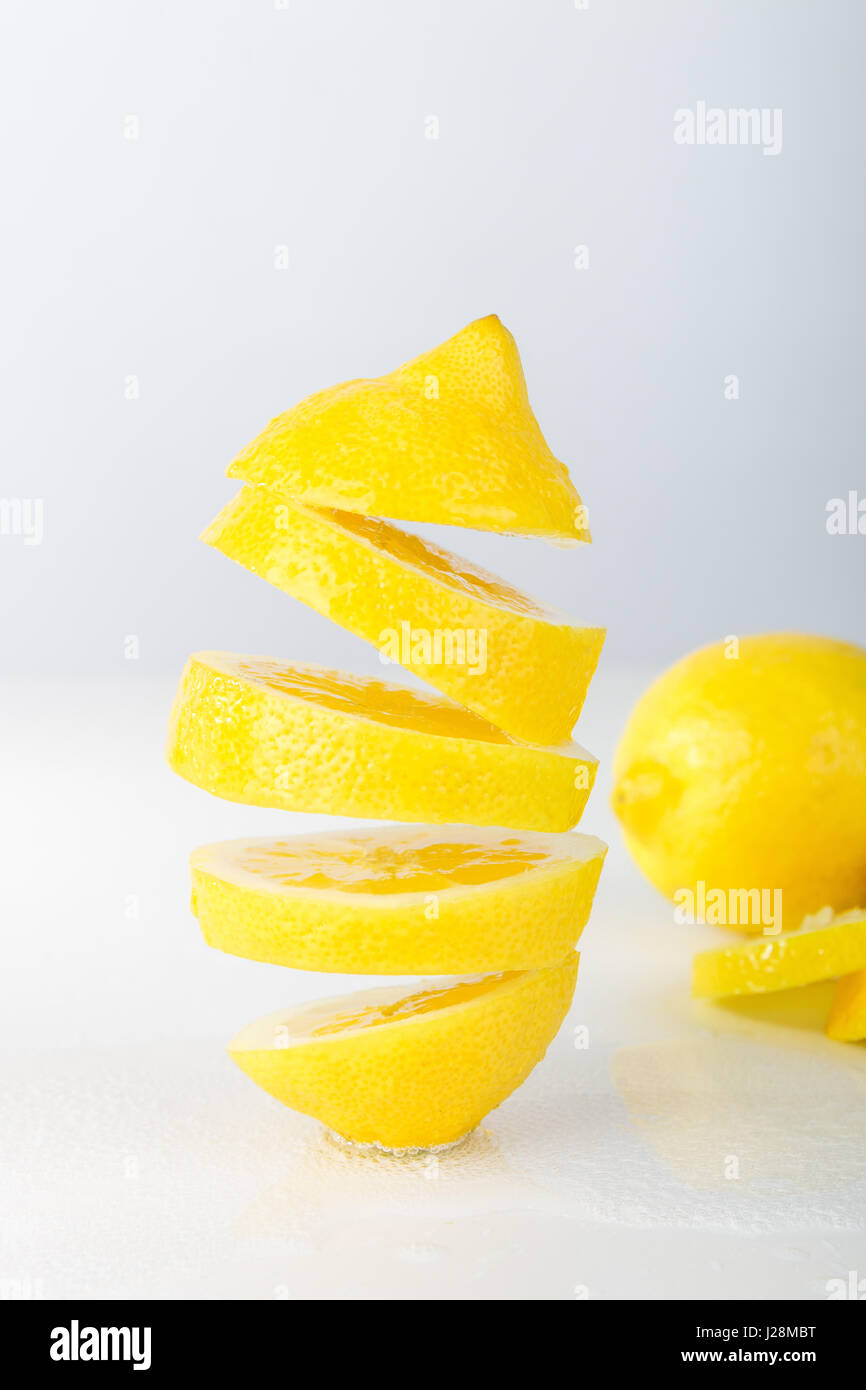 Flying lemon. Sliced lemon on white background. Levity fruit floating ...