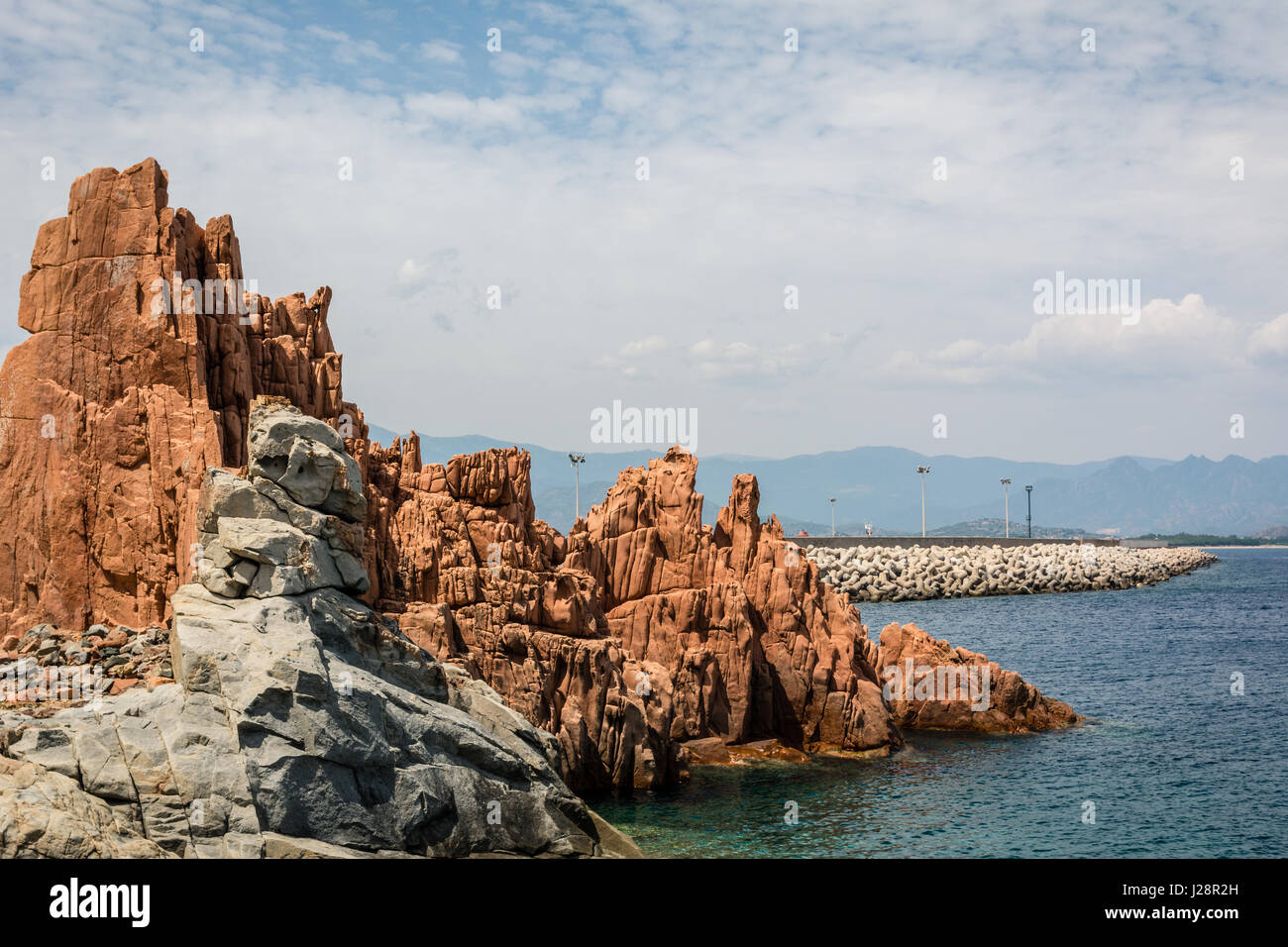 Red rocks of Arbatax city, Sardinia, Italy. Pier, beautiful blue sky ...