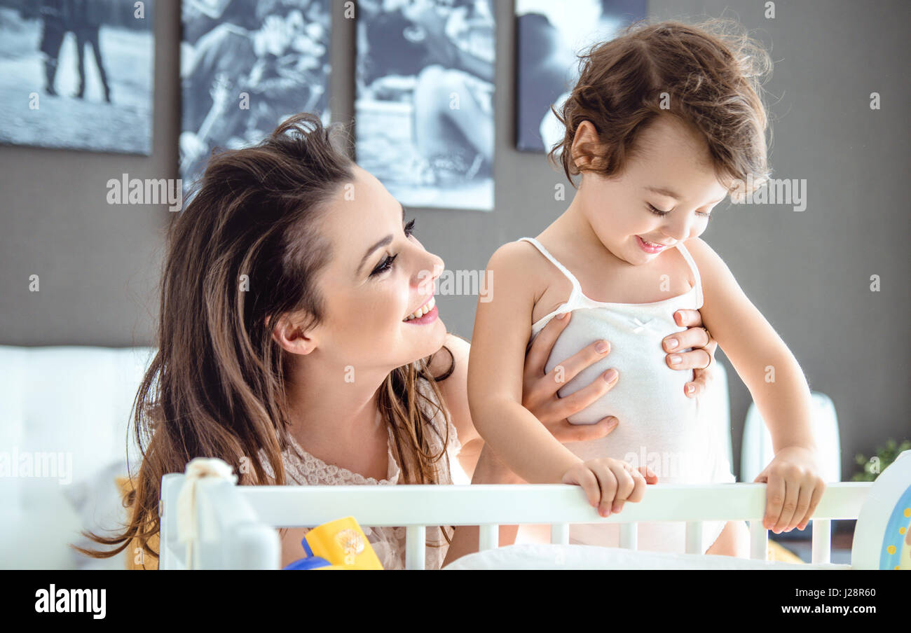 Cheerful young mother hugging her beloved daughter Stock Photo - Alamy