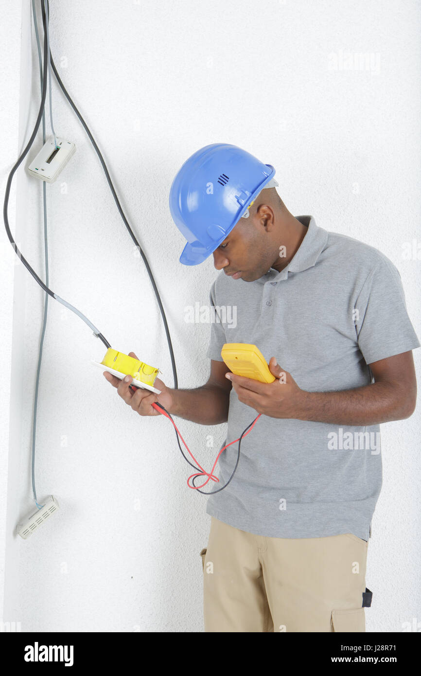 Electrician testing switch with multimeter Stock Photo - Alamy