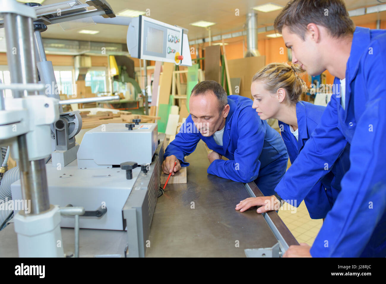teacher with students in workshop Stock Photo - Alamy
