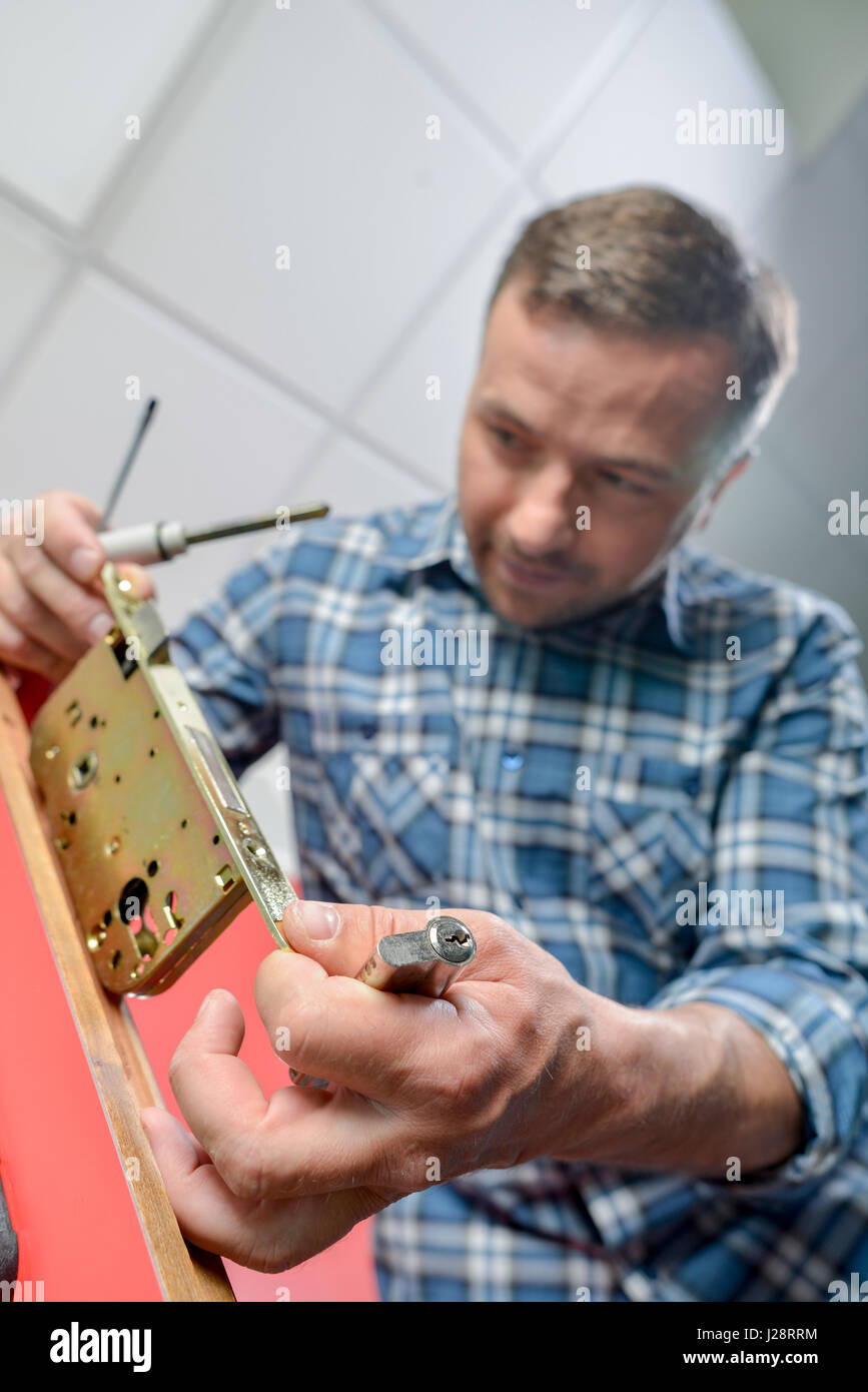 man installing door lock Stock Photo - Alamy
