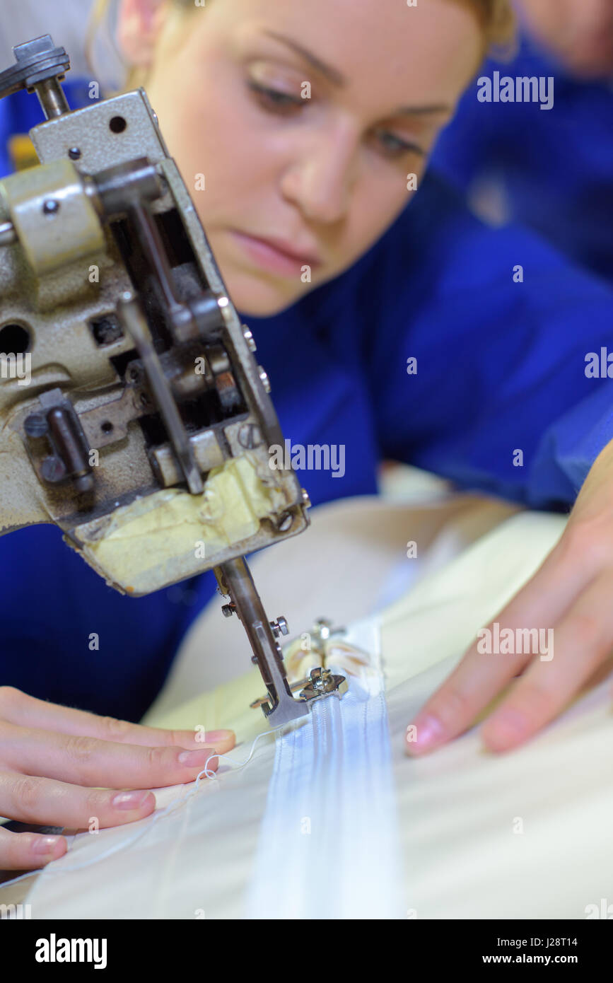 Woman using sewing machine Stock Photo - Alamy