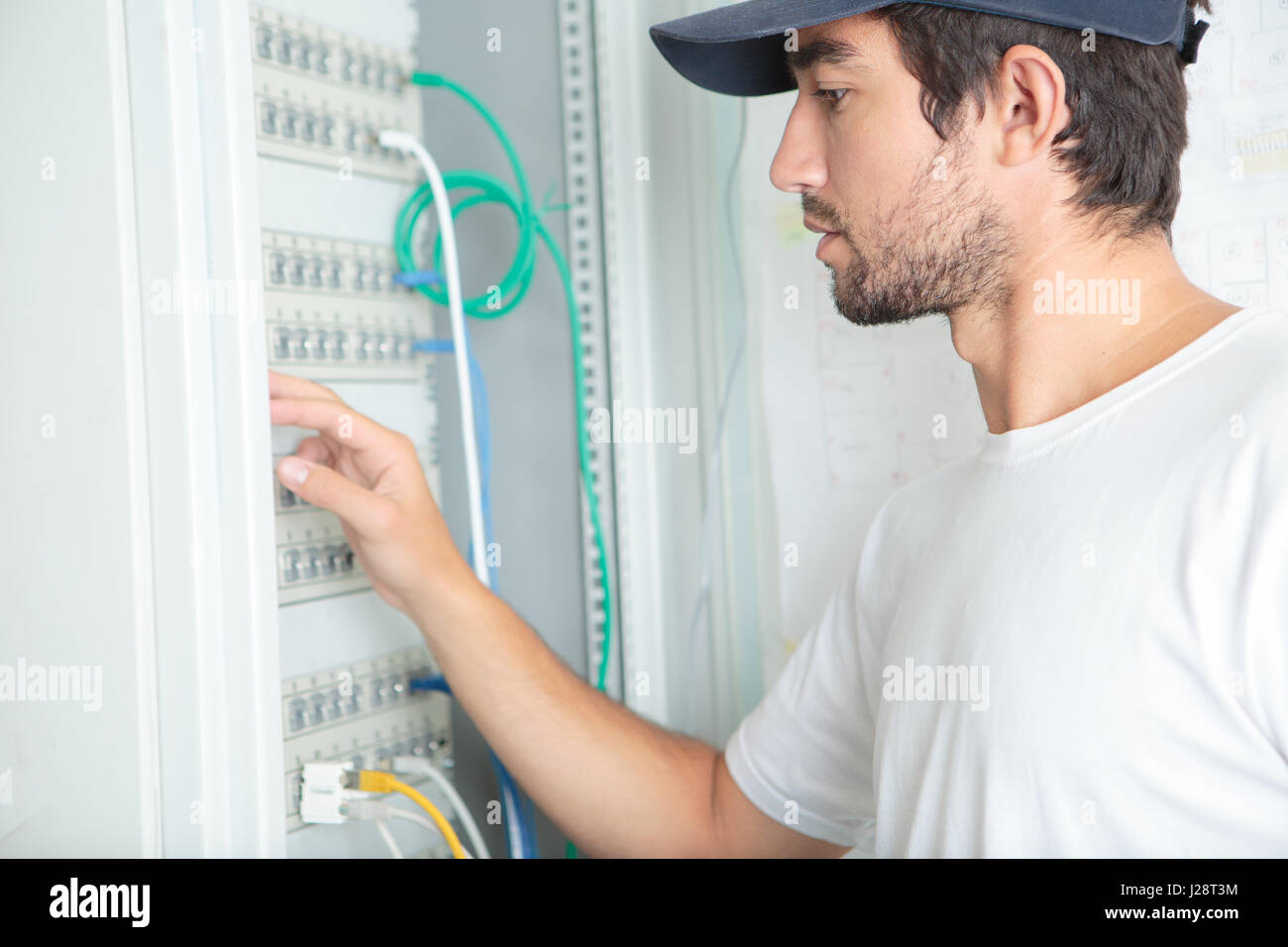Electrician wiring up cabinet Stock Photo - Alamy