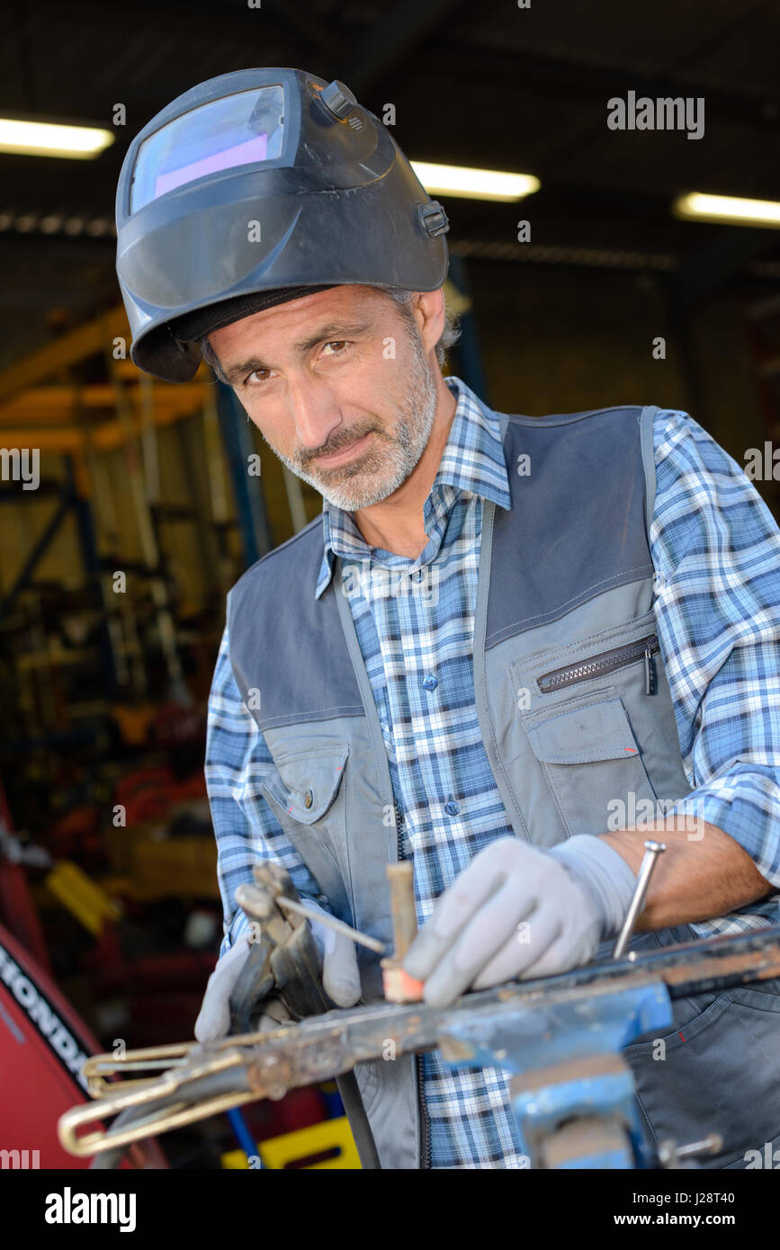 Portrait of man wearing welding mask Stock Photo - Alamy