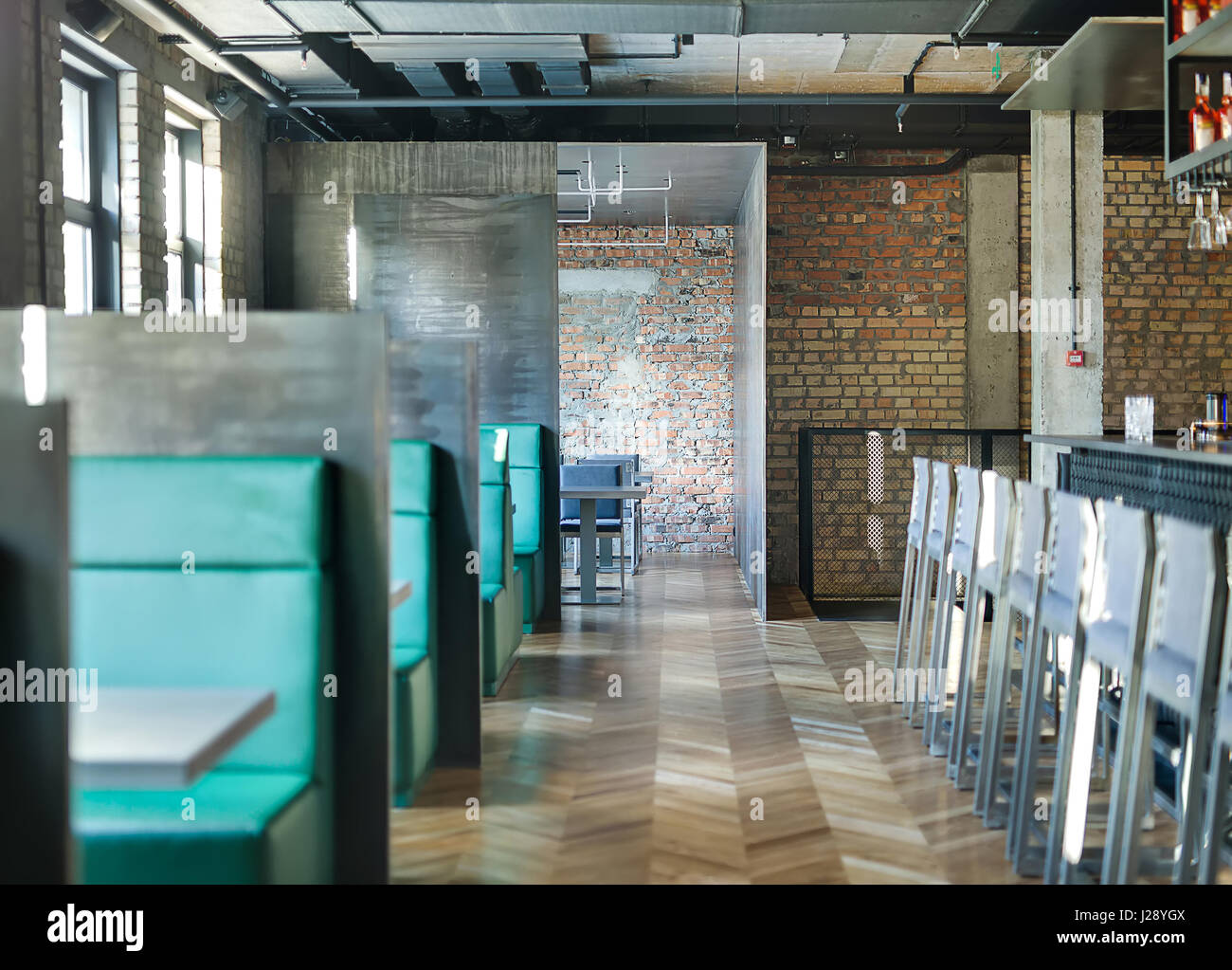 Restaurant in a loft style with brick walls and concrete columns. There ...