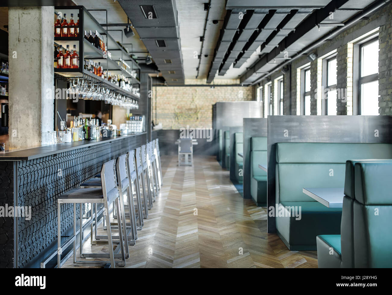Stylish restaurant in a loft style with brick walls and a concrete ...