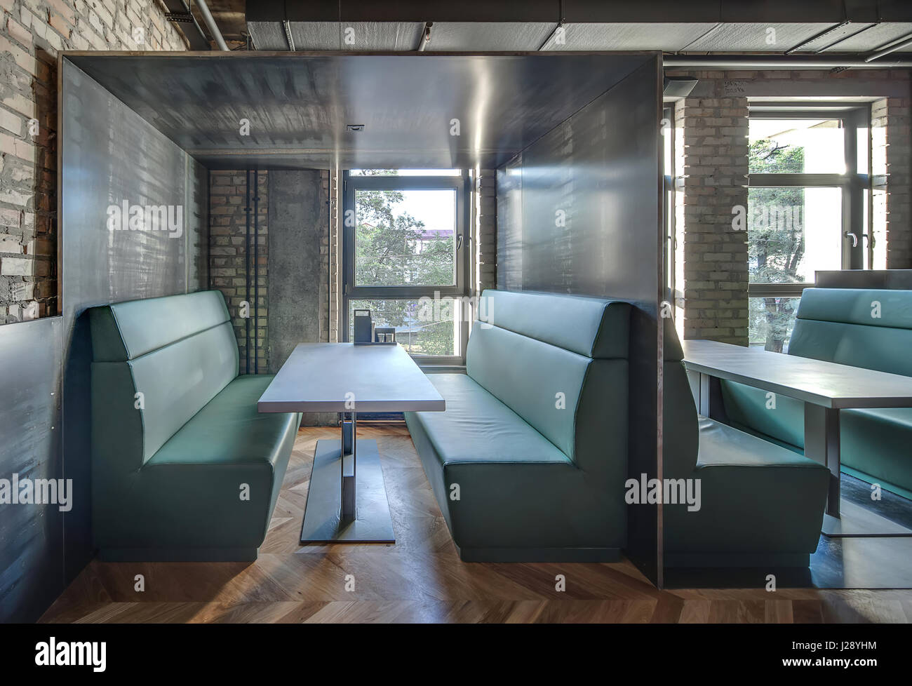 Nice cafe in a loft style with brick walls and a parquet on the floor ...