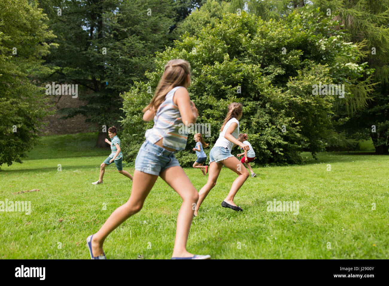 group of happy kids or friends playing outdoors Stock Photo - Alamy