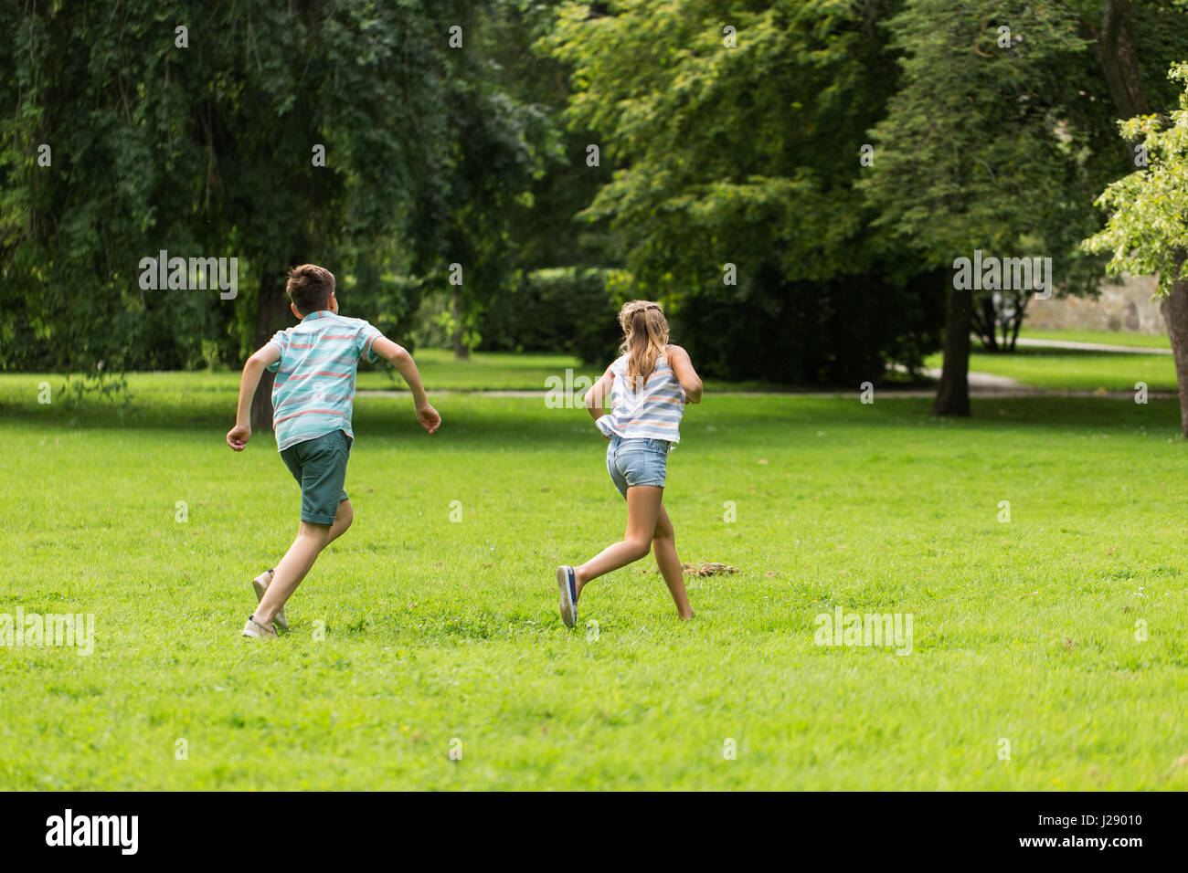 group of happy kids or friends playing outdoors Stock Photo - Alamy