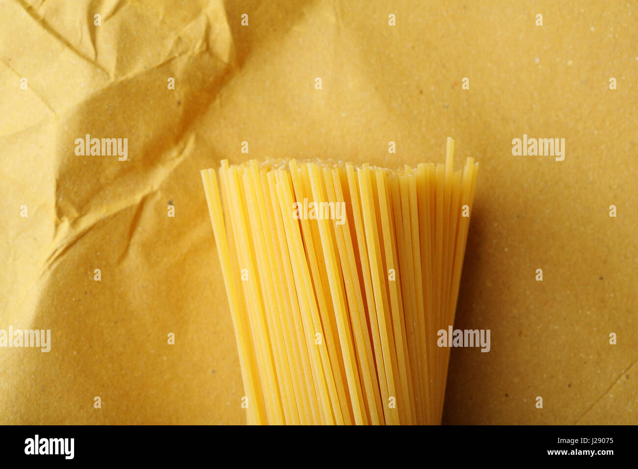 Yellow pasta on yellow background, food Stock Photo - Alamy