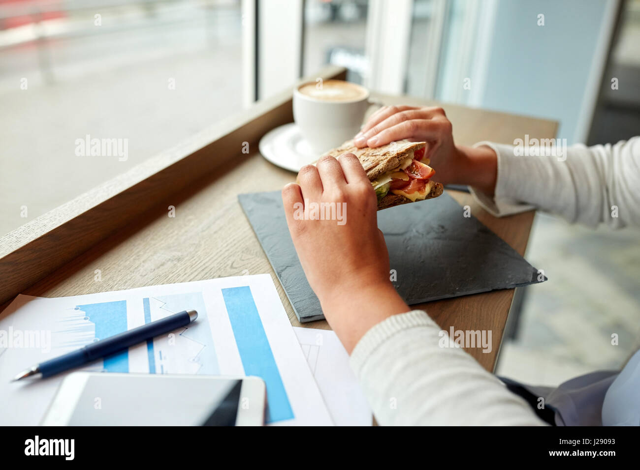 woman eating salmon panini sandwich at cafe Stock Photo - Alamy