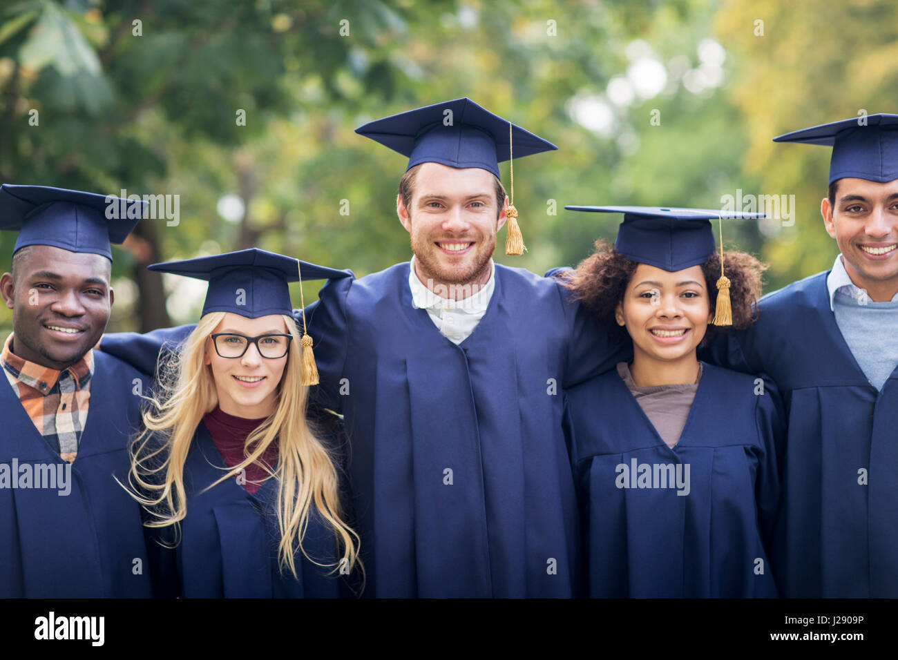 happy students or bachelors in mortar boards Stock Photo - Alamy
