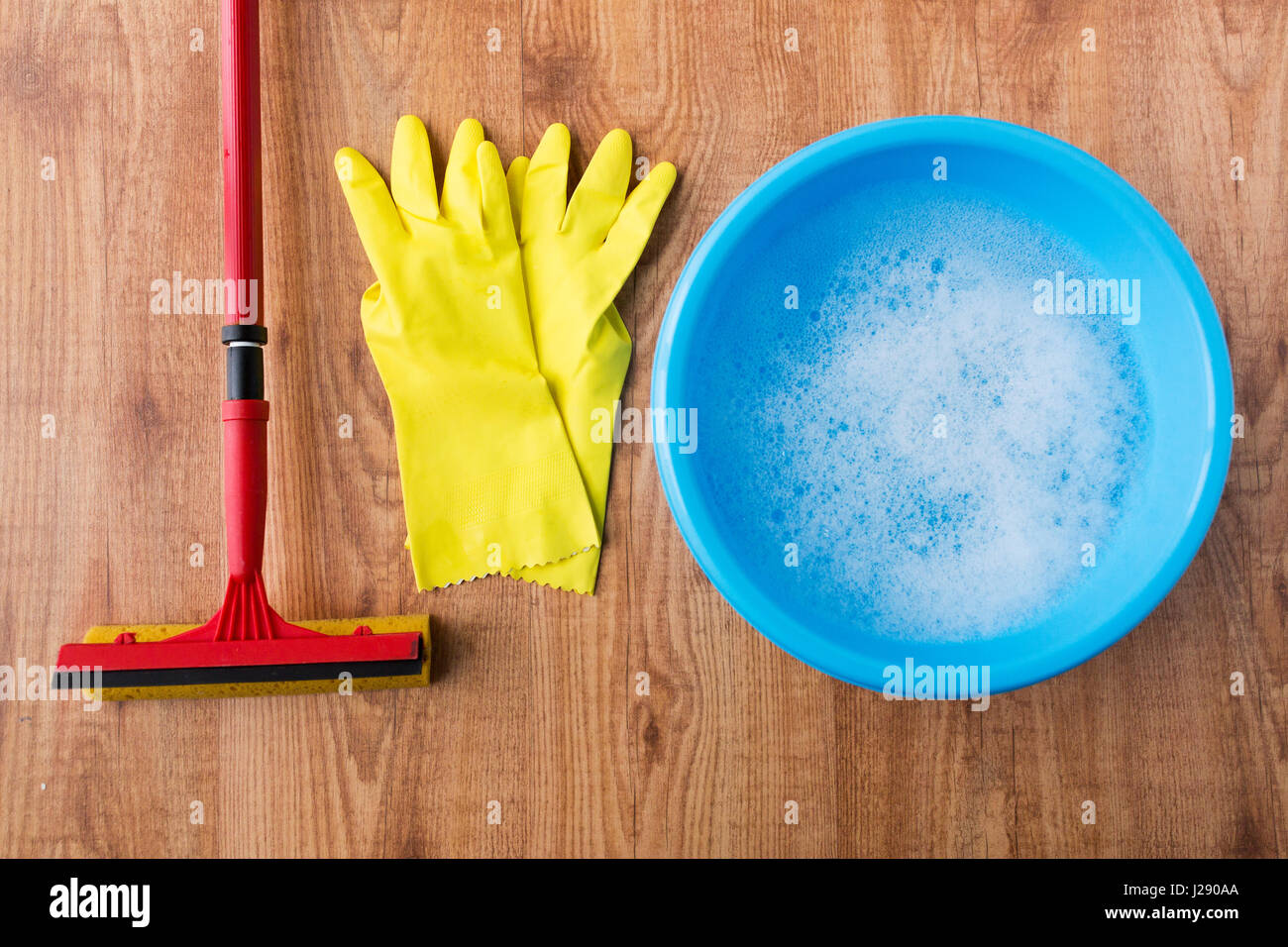 basin with cleaning stuff on wooden background Stock Photo - Alamy